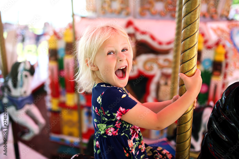 Happy Excited Little Girl Riding the Carousel at a Carnival Stock Photo ...