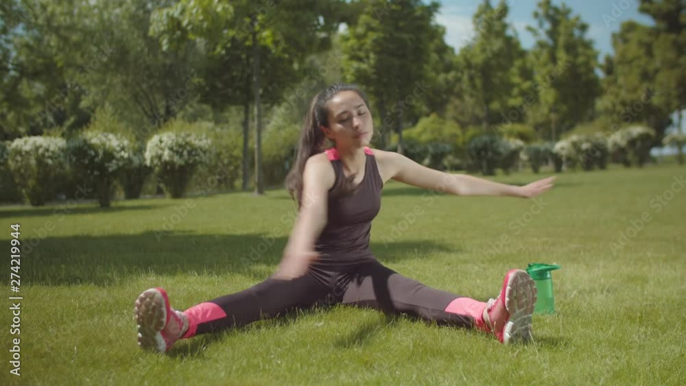 Chinese female athlete doing sport exercise on lateral muscles of back ...