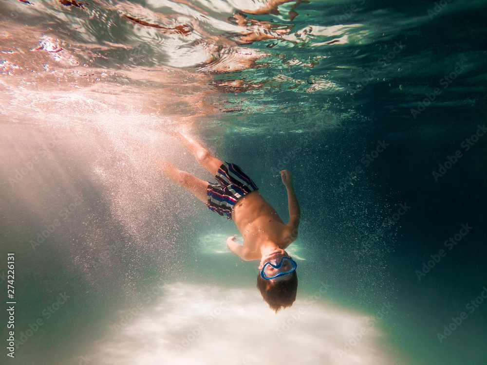 Boy diving into a swimming pool Stock Photo | Adobe Stock