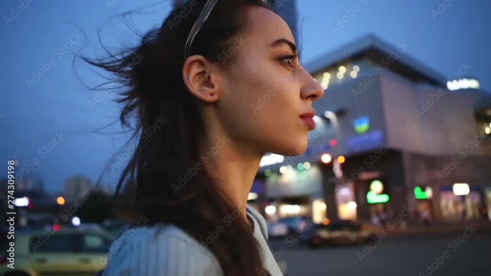 pretty woman smiling and looking at the camera outdoors. urban portrait ...