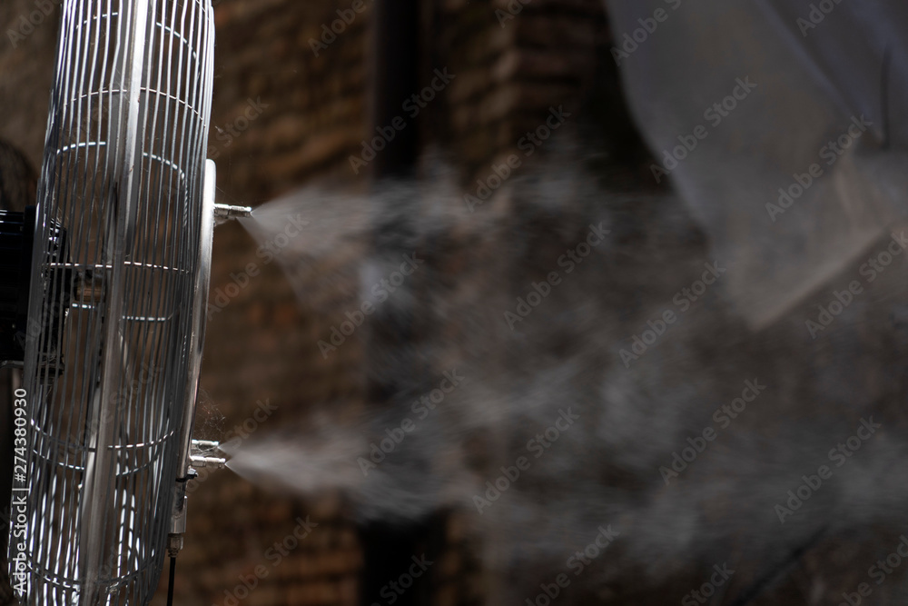 refresher fan with cold water spray Stock Photo | Adobe Stock