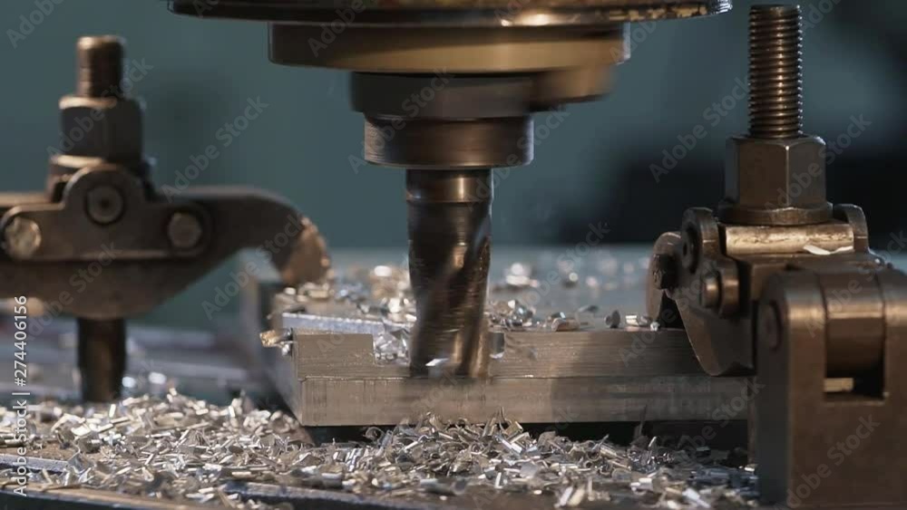 Close up milling machine in operation cutting steel in a high-tech ...