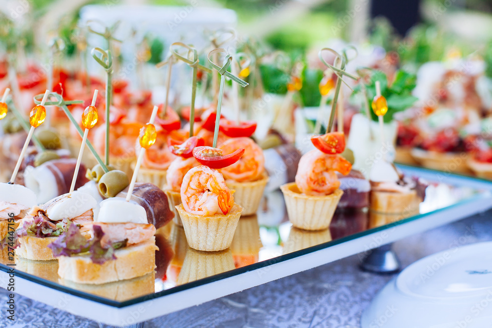 Beautifully decorated catering banquet with different food snacks and ...