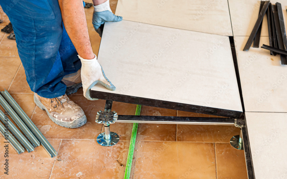 Foto de Worker working Raised floor in modern interior of server room ...