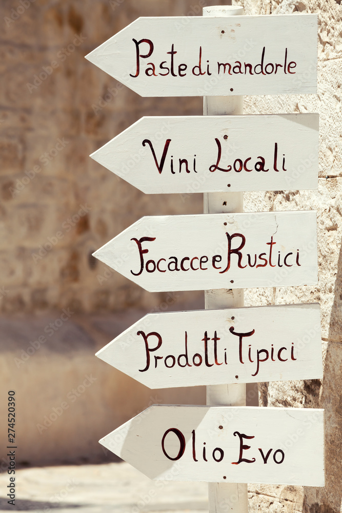 Wood white signs arrowhead with typical products of Italys southern ...