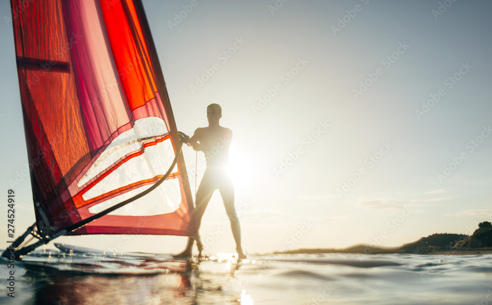 Windsurfer on windsurf board on the sunset sea, copy space foto de ...