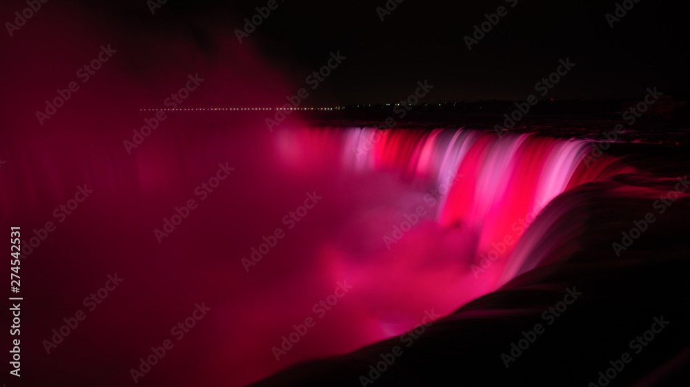 Niagara Falls is illuminated in glowing red colours Stock Photo | Adobe ...
