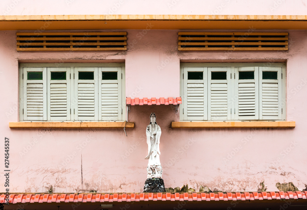 Buddha statue in the front of the old shop house window facade Stock ...