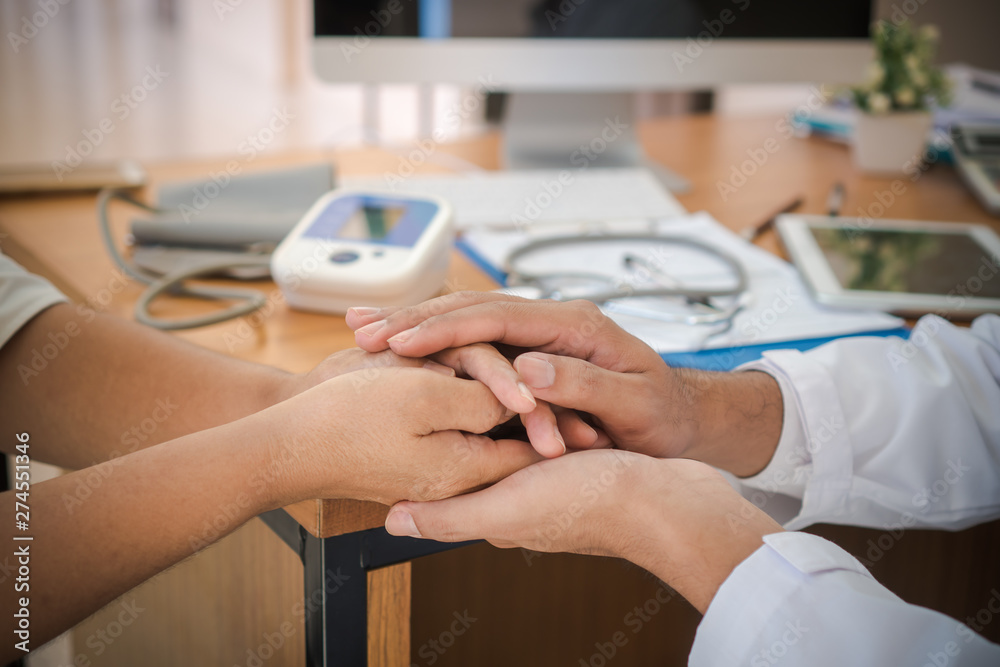 Asian hands doctor reassuring or holding hand older patient with ...
