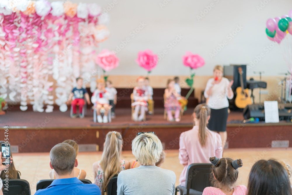 Children's party in primary school. Young children on stage in ...