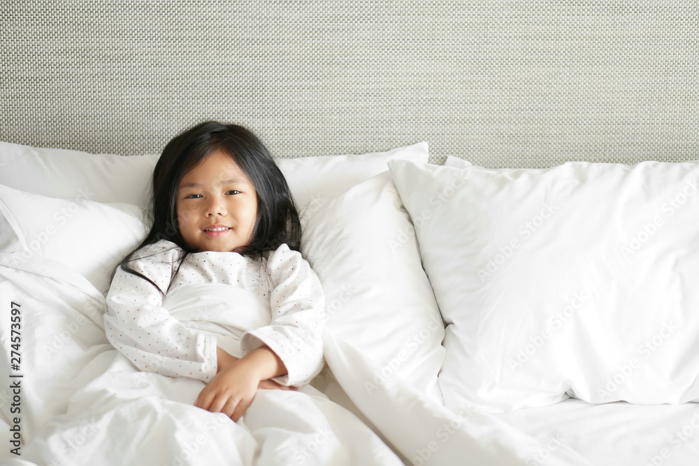 Asian child cute relax or kid girl sleep and smiling happy wake up with ...