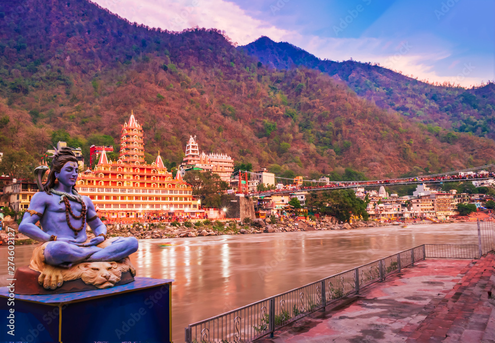 Idol of Indian God Shiva, at the bank of river Ganga in Rishikesh with ...