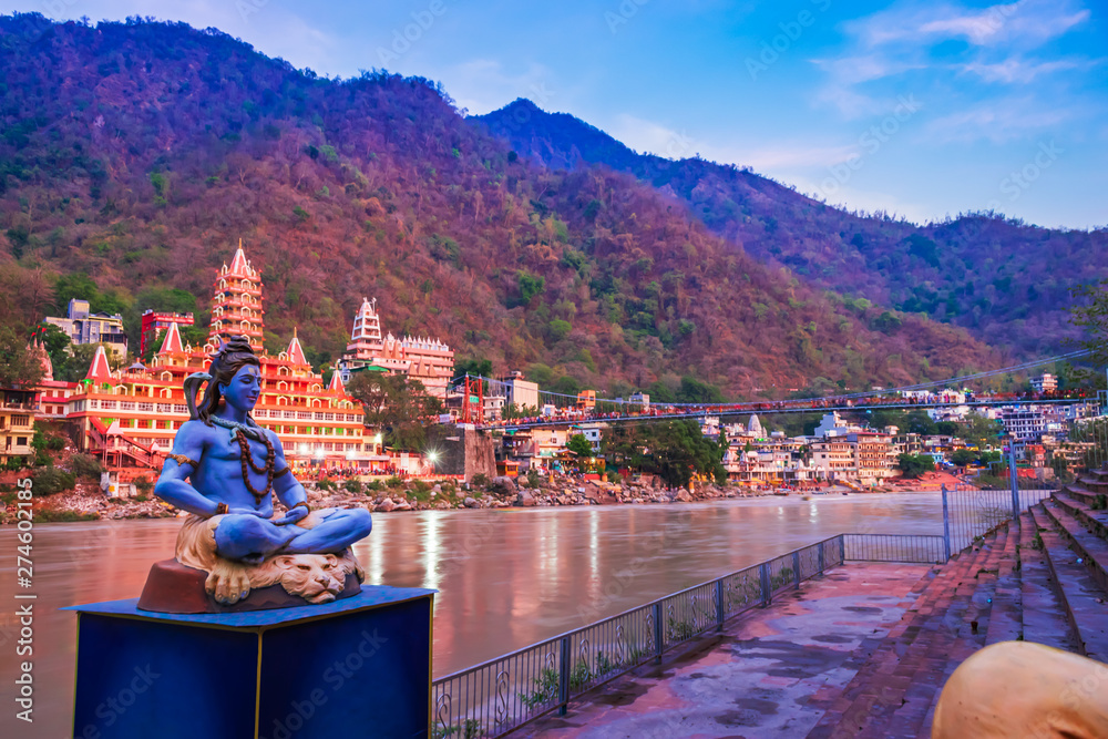 Idol of Indian God Shiva, at the bank of river Ganga in Rishikesh with ...