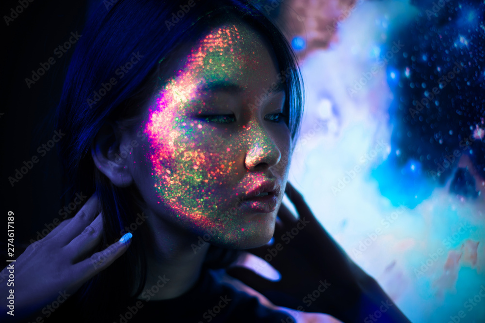 Beautiful young woman dancing and making party with fluorescent ...