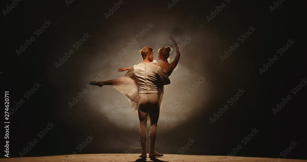 Professional Duet Of Ballet Dancers Performing On Stage Isolated On