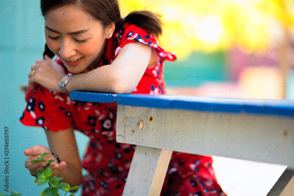 girl in red dress smile relaxing emotional sit table blue color in ...