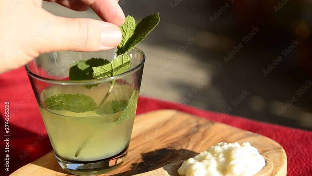 Water kefir drink with fresh mint leaves. Probiotic drink without dairy ...