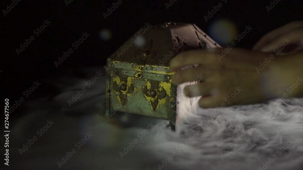 This slow motion video shows anonymous hands opening a mysterious ...
