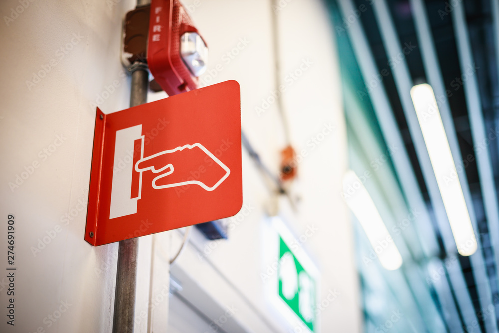 Fire alarm sign on the wall next to the door, Safety warning symbol ...
