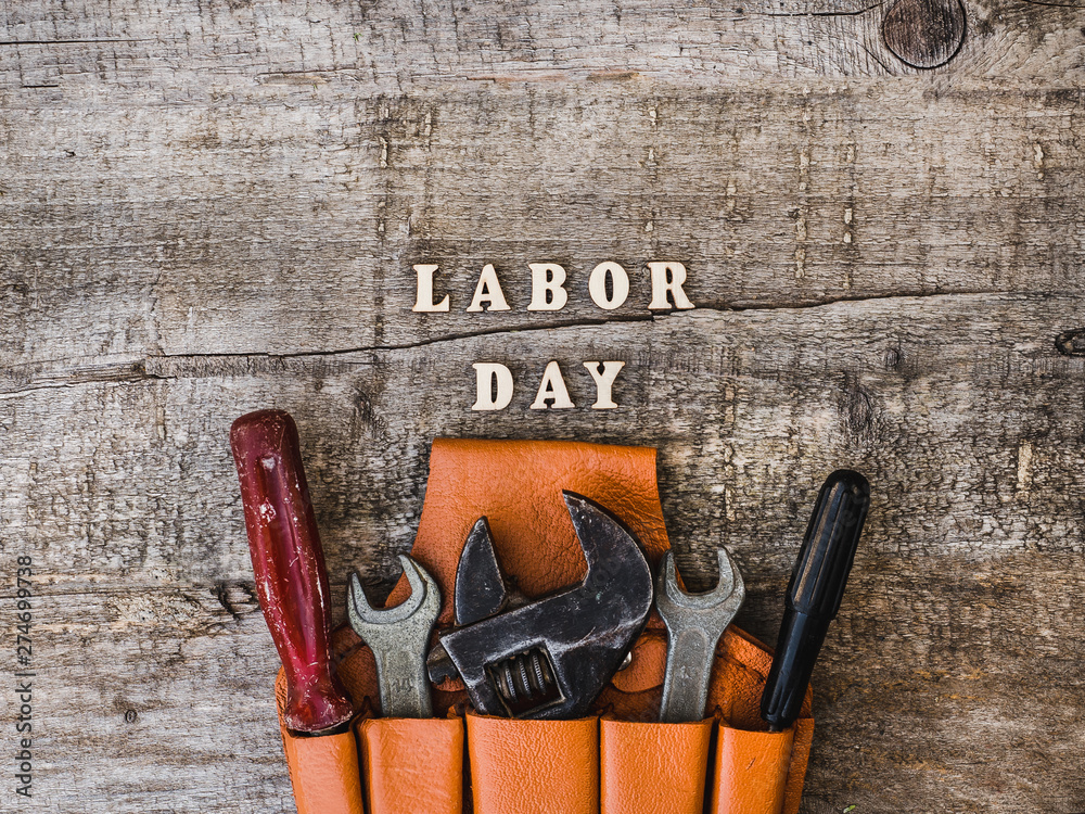 Stockfoto LABOR DAY. Hand tools and wooden letters lying on the desk ...