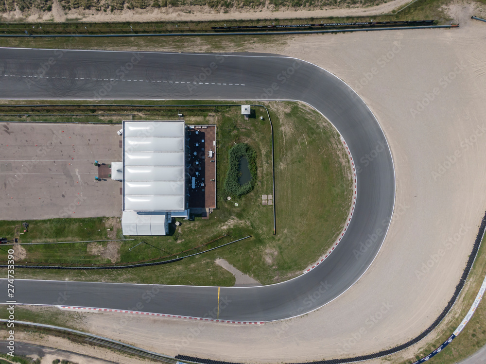 Top down aerial view of curve in motor sport race track circuit with ...