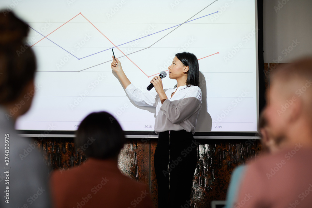 Side view portrait of contemporary businesswoman giving presentation ...