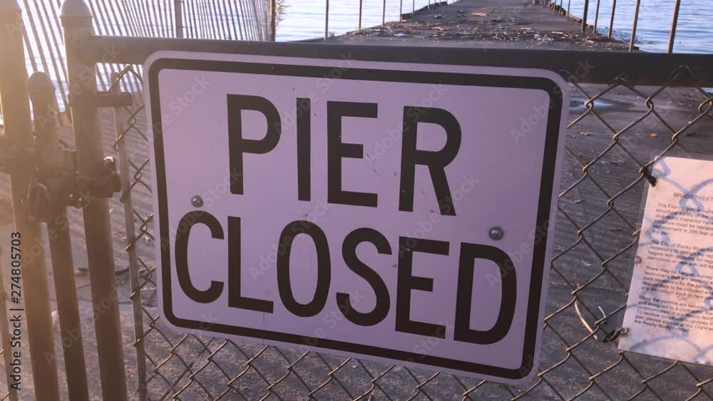 Pier closed signs of danger where a beach is not safe and falling into ...