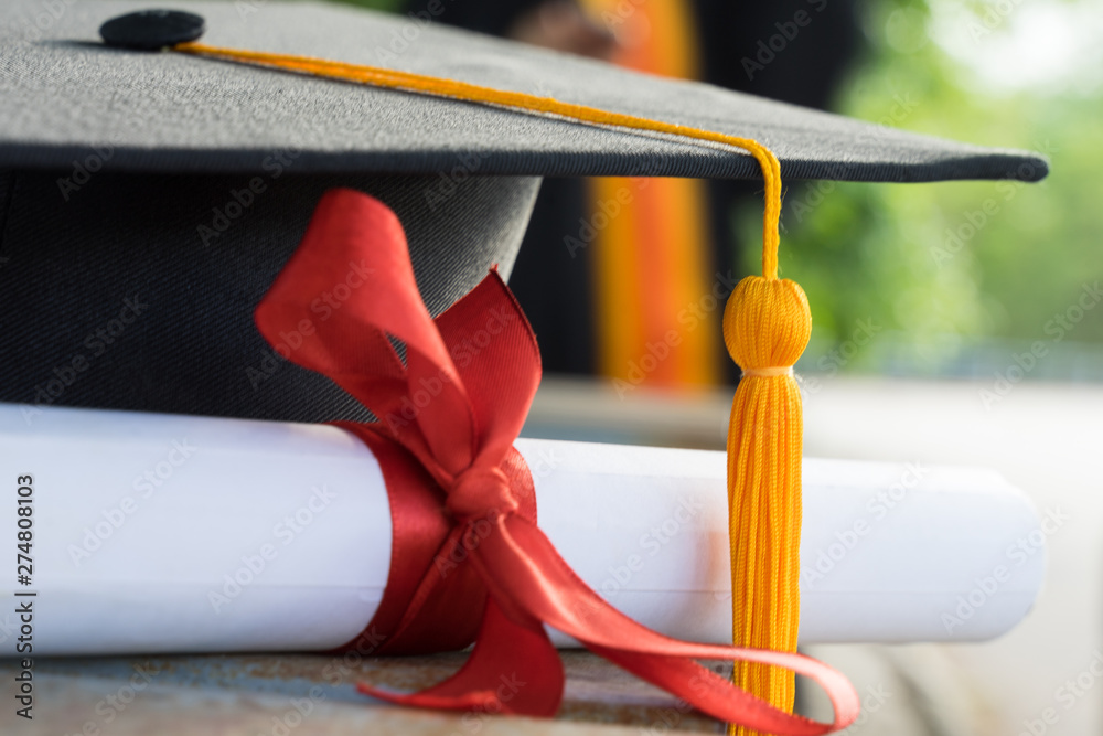Close up focus of university graduate holds degree certificate and ...