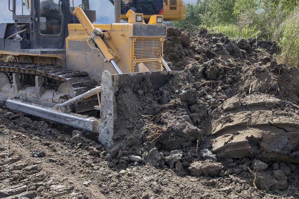 the process of operating a modern bulldozer in the preparation of a new ...