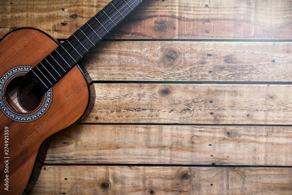 Acoustic guitar on vintage style wood background. Copy space with ...