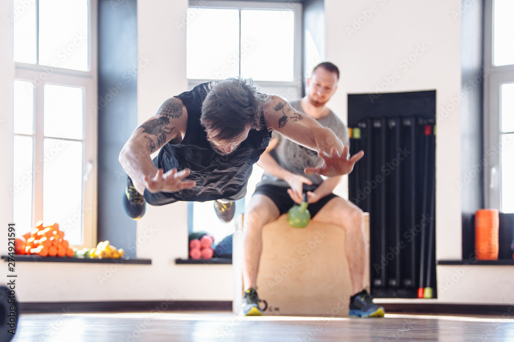 Two friends of men athletes doing strength training and interval ...