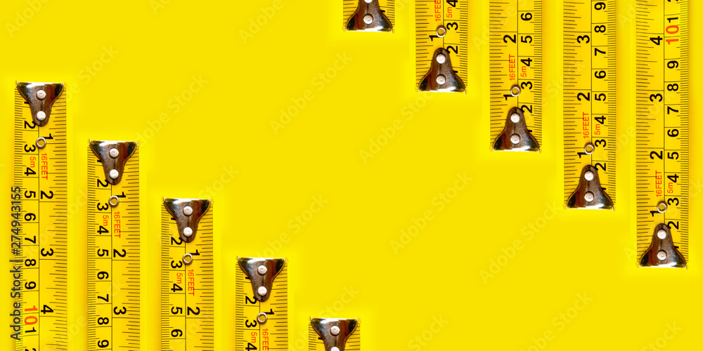 Yellow measurFrame yellow measuring tape on yellow background and ...