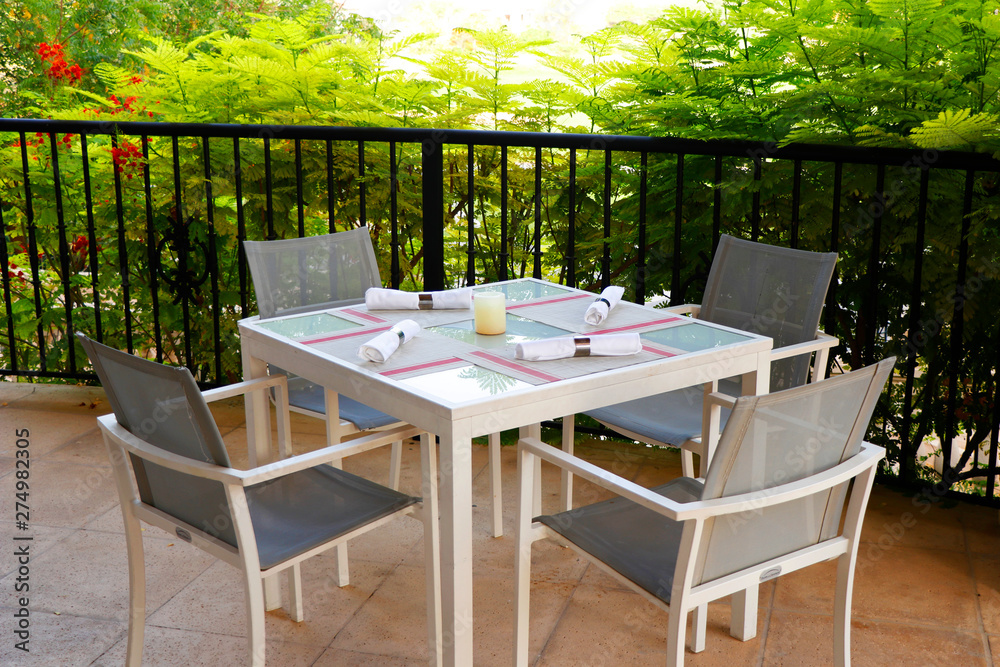 simple dining table set up in open terrace with beautiful nature view ...