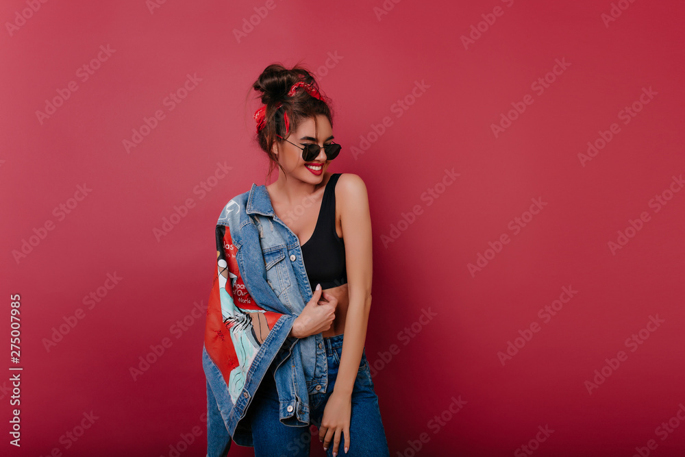 Happy dark-haired woman wears denim clothes spending time on photoshoot ...