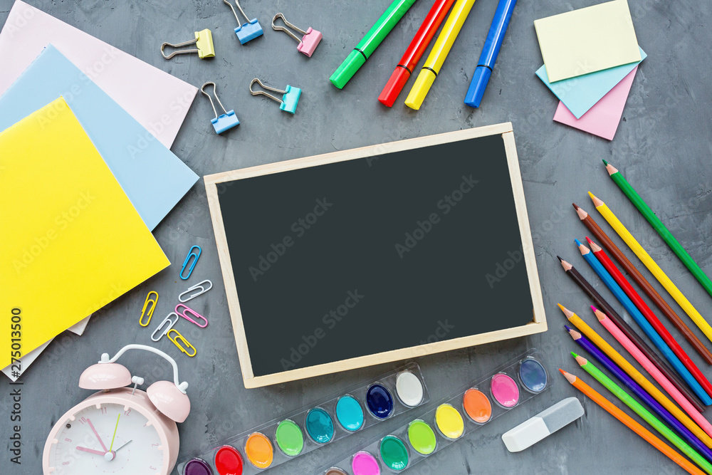 School supplies stationery, colour pencils, paints, paper on gray ...