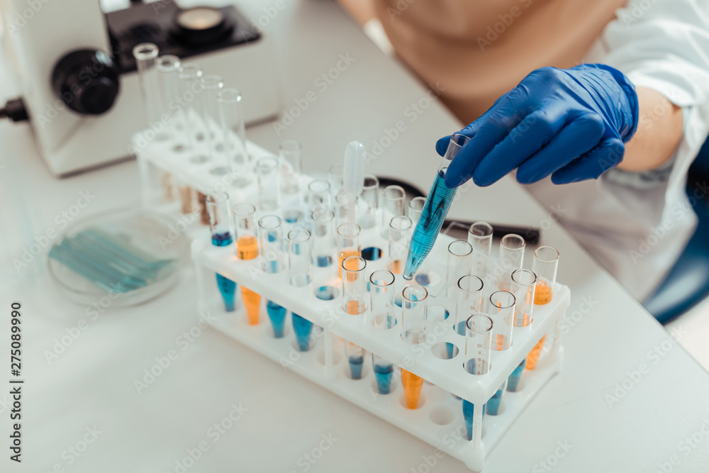 Top view of a test tube being taken for analysis Stock Photo | Adobe Stock