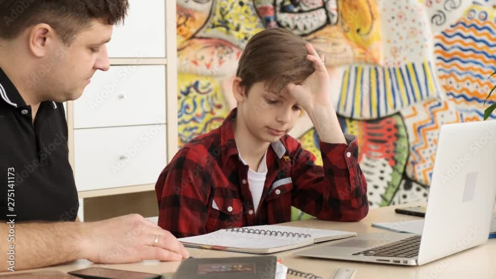 Stockvideon Angry dad argues his upset son for wrong made hometask at ...