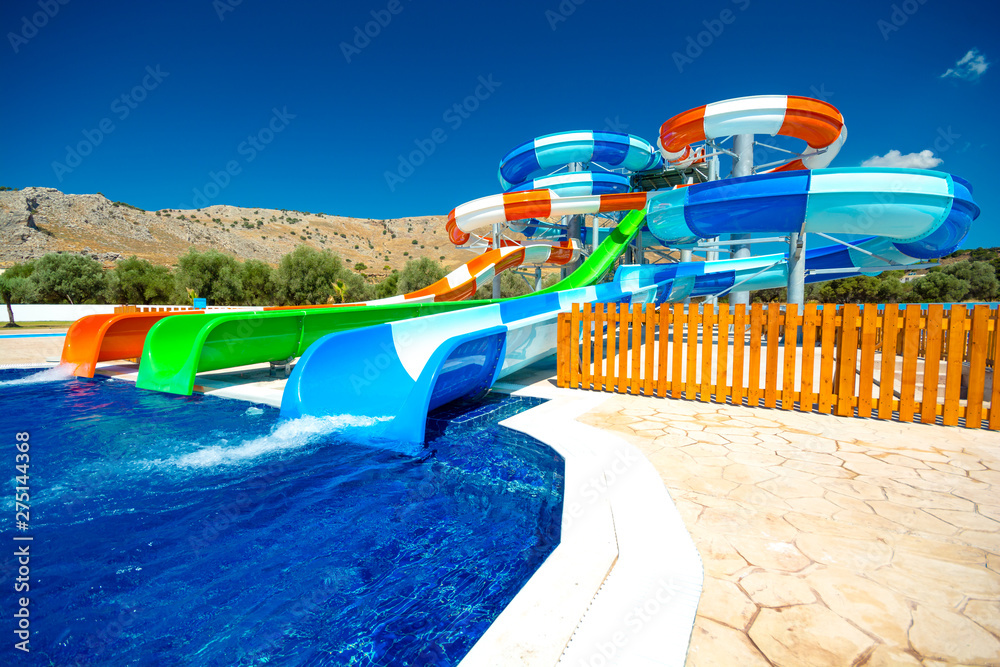 colorful open-air water slides with a stream of water, view at an angle ...