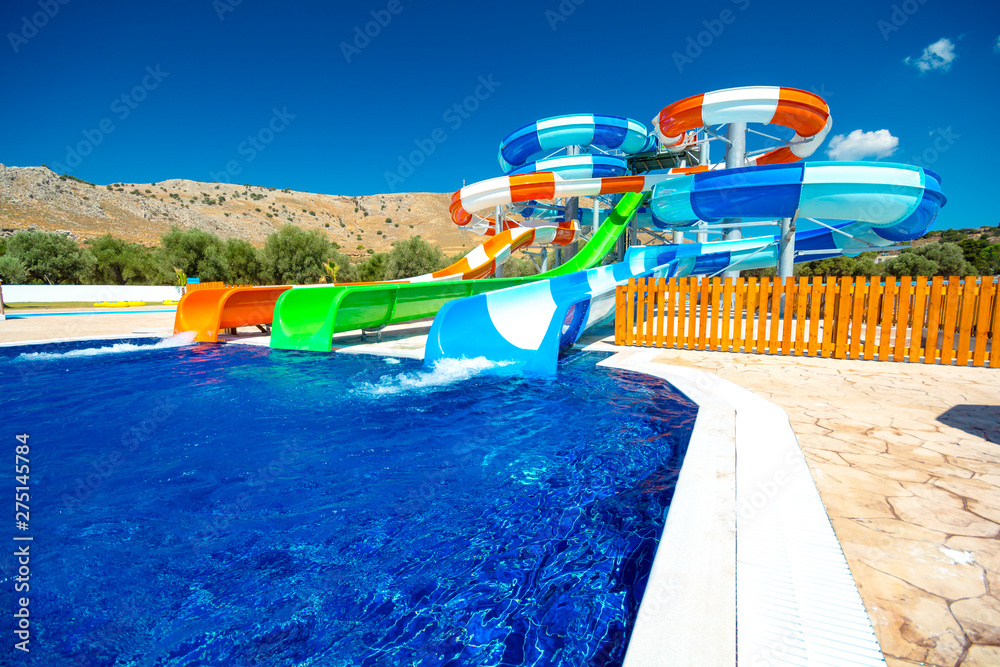 colorful open-air water slides with a stream of water, wide view at an ...