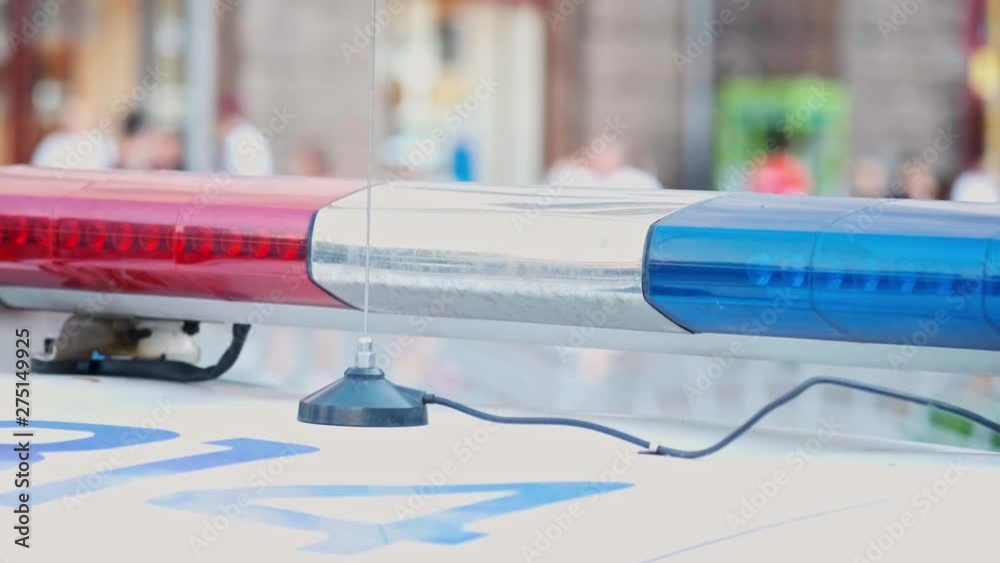 Police blue and red flashing lights on the city street, close-up ...
