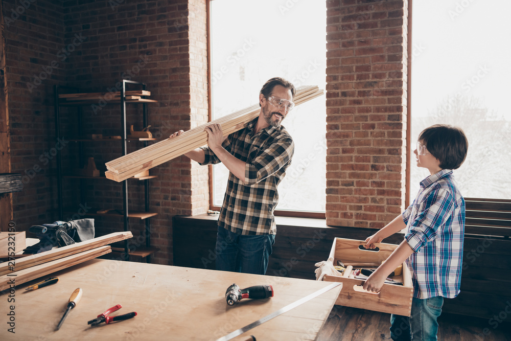 Two nice cheerful cheery hard-working person master builder hard ...