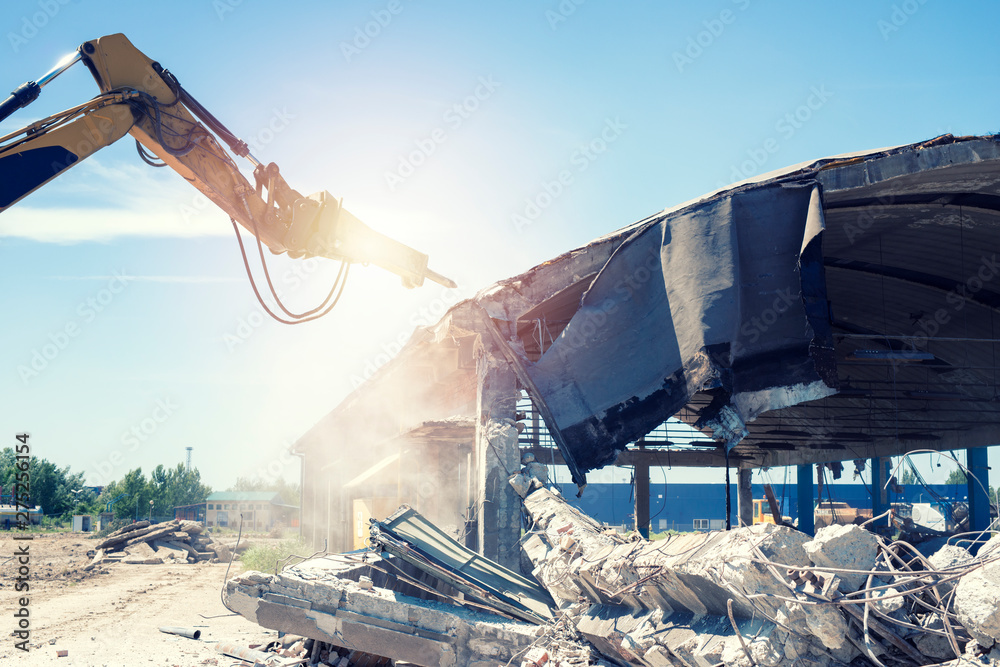 Old industrial buildings being demolished and destroyed by construction ...