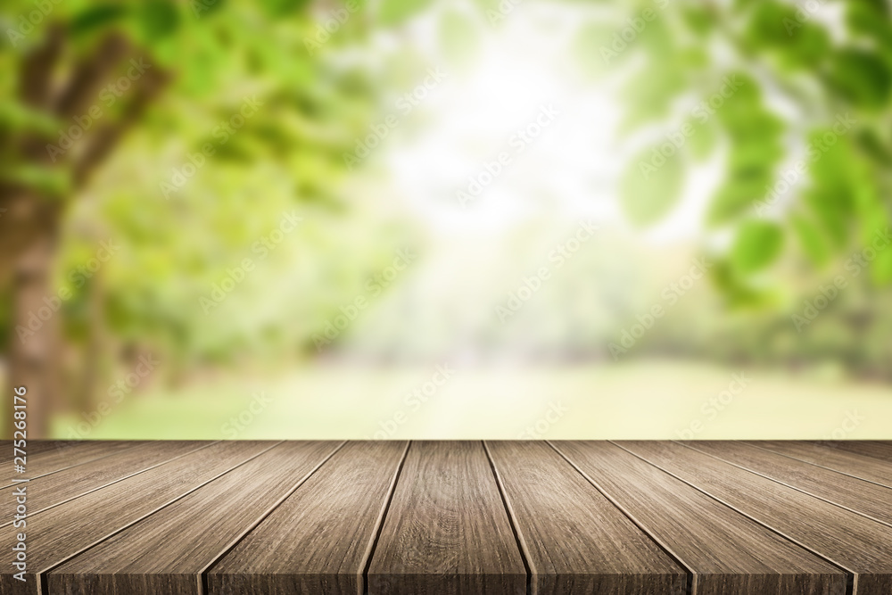Empty wooden table with garden bokeh for a catering or food background ...