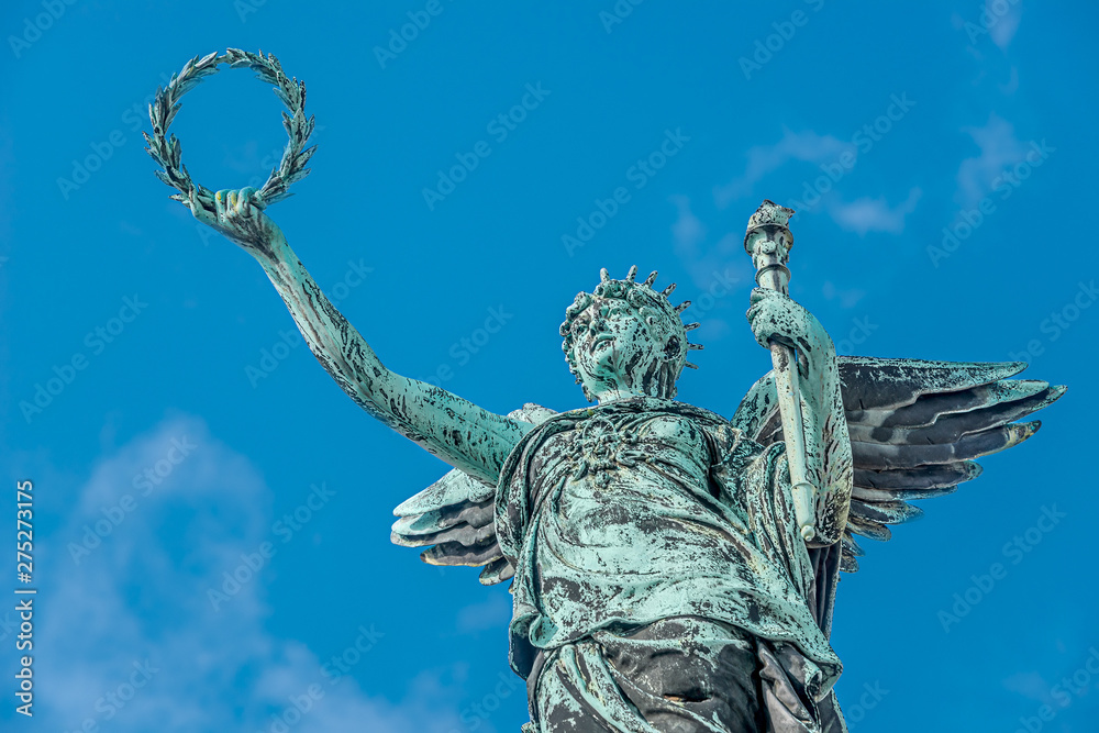 Top column statue of sensual Renaissance era angel with wings and ...