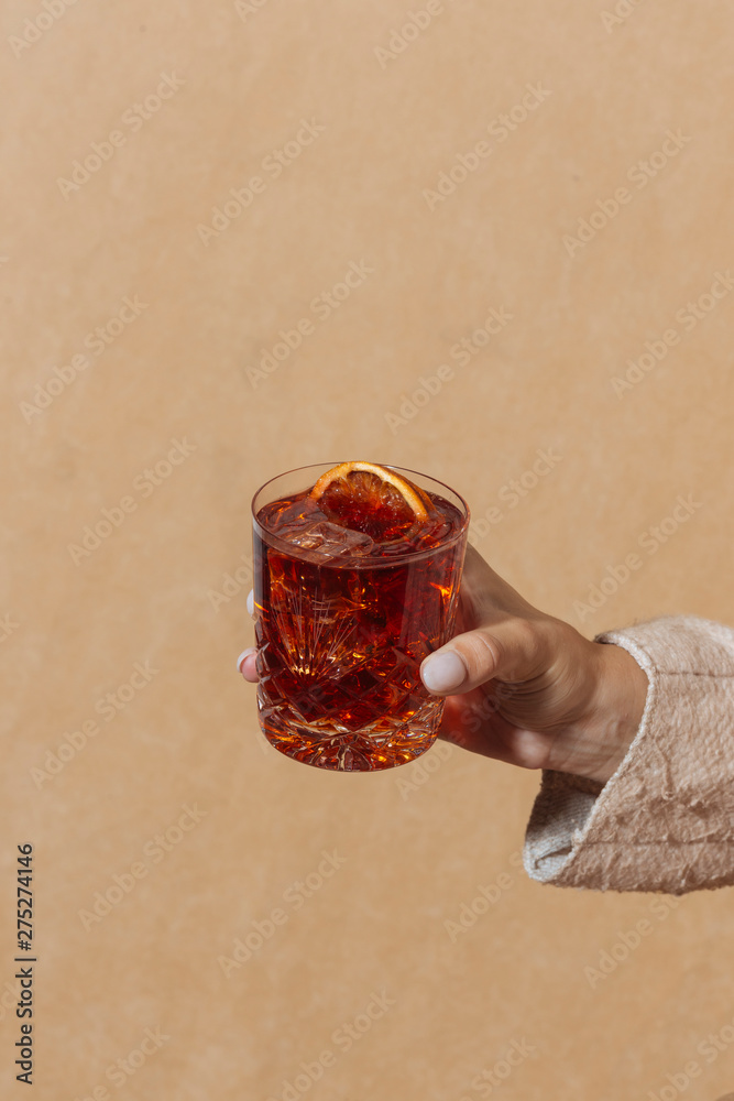 Woman helding Negroni, an italian cocktail. First mixed in Firenze ...