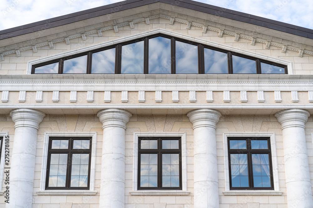 Beautiful window in a classic building with white walls. In the glass ...