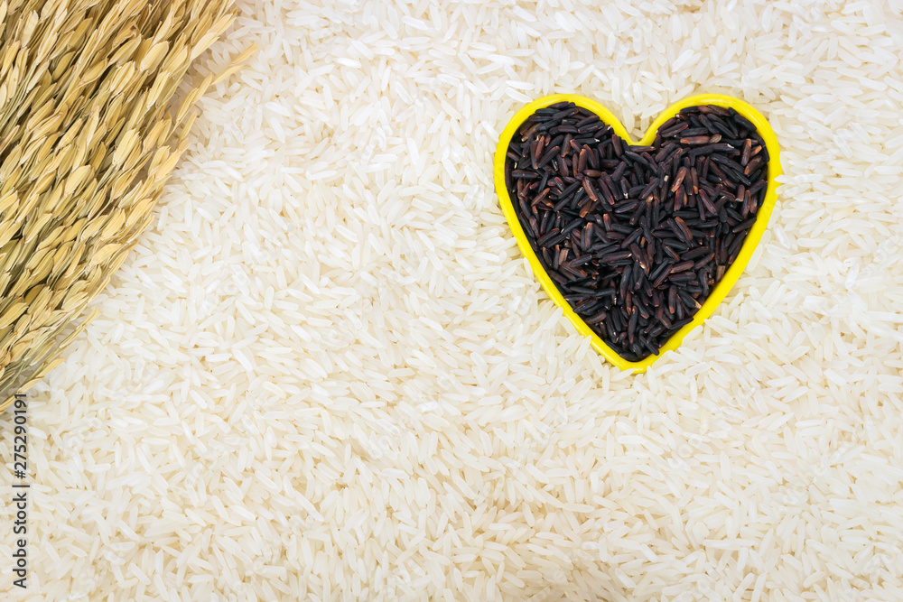 Heart shape of rice berry grains on white rice background; protects ...
