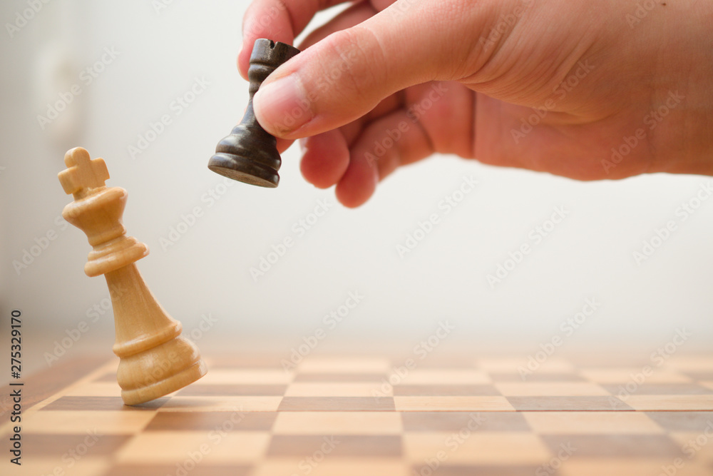 Foto de black tower hitting a white king, chess game end with a ...