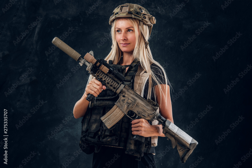 Beautiful fragile blond girl with machine gun in full army uniform and ...