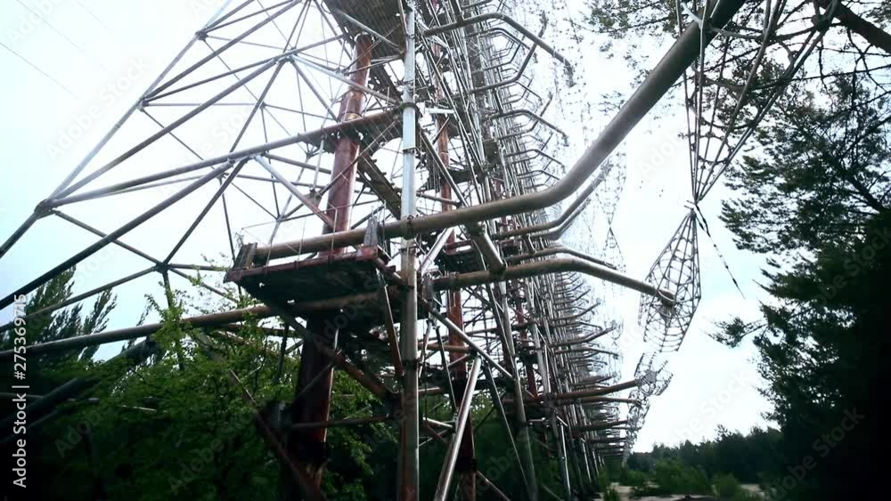 Dark tourism in Prypiat, Ukraine. View of massive antenna tower used to ...